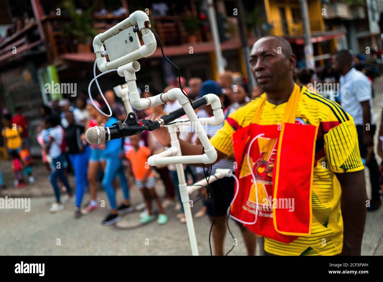An Afro-Colombian video journalist covers a parade of the Roma ...