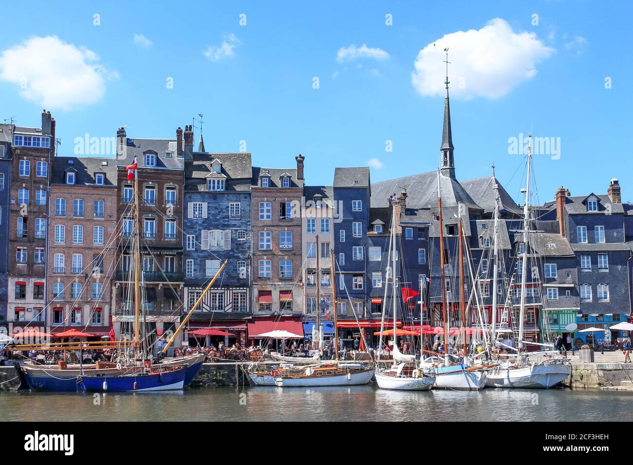 French town street with beautiful colorful houses and yachts in the bay ...