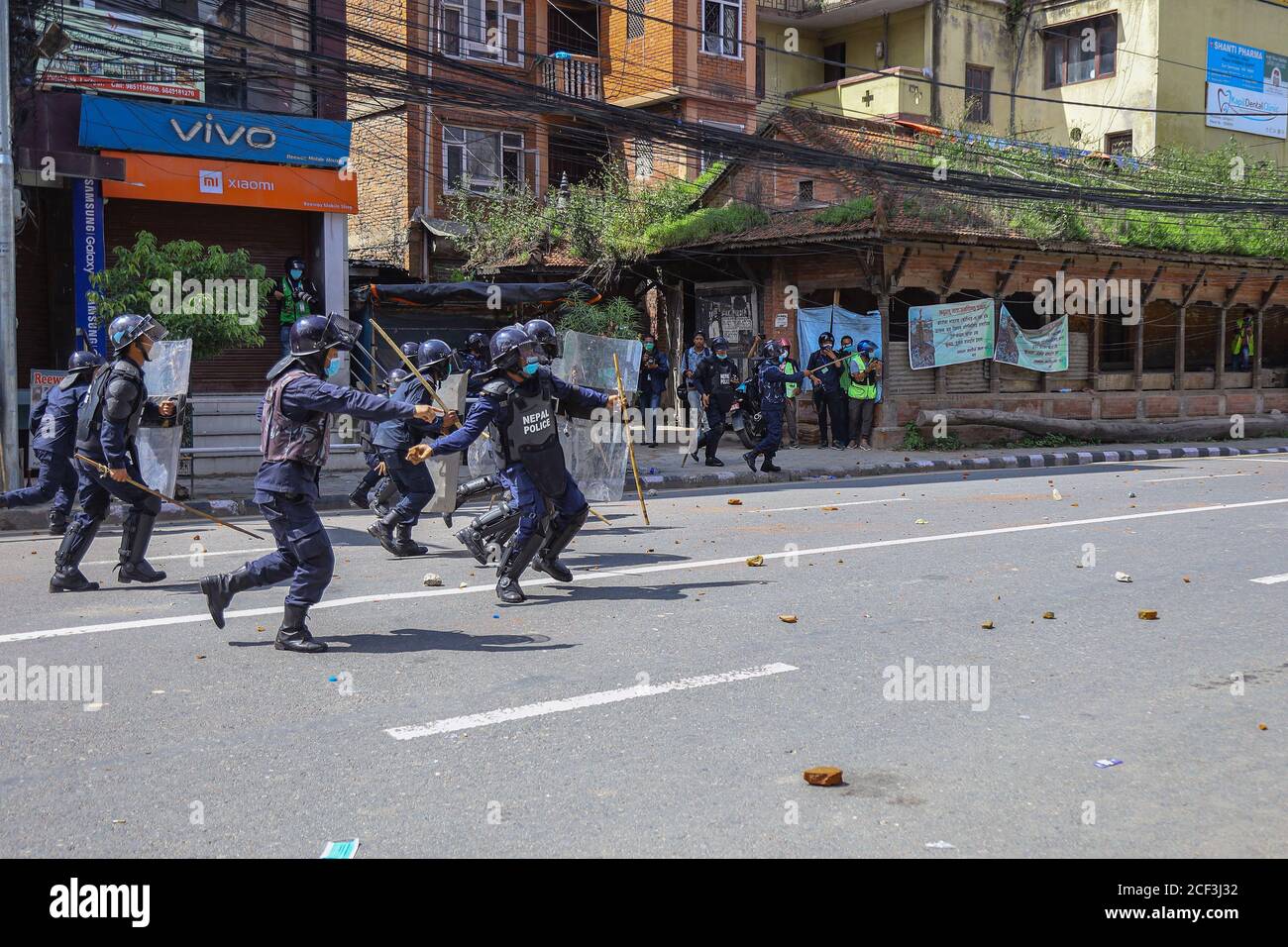 Lalitpur, Nepal. 03rd Sep, 2020. Nepalese policemen throw stones ...