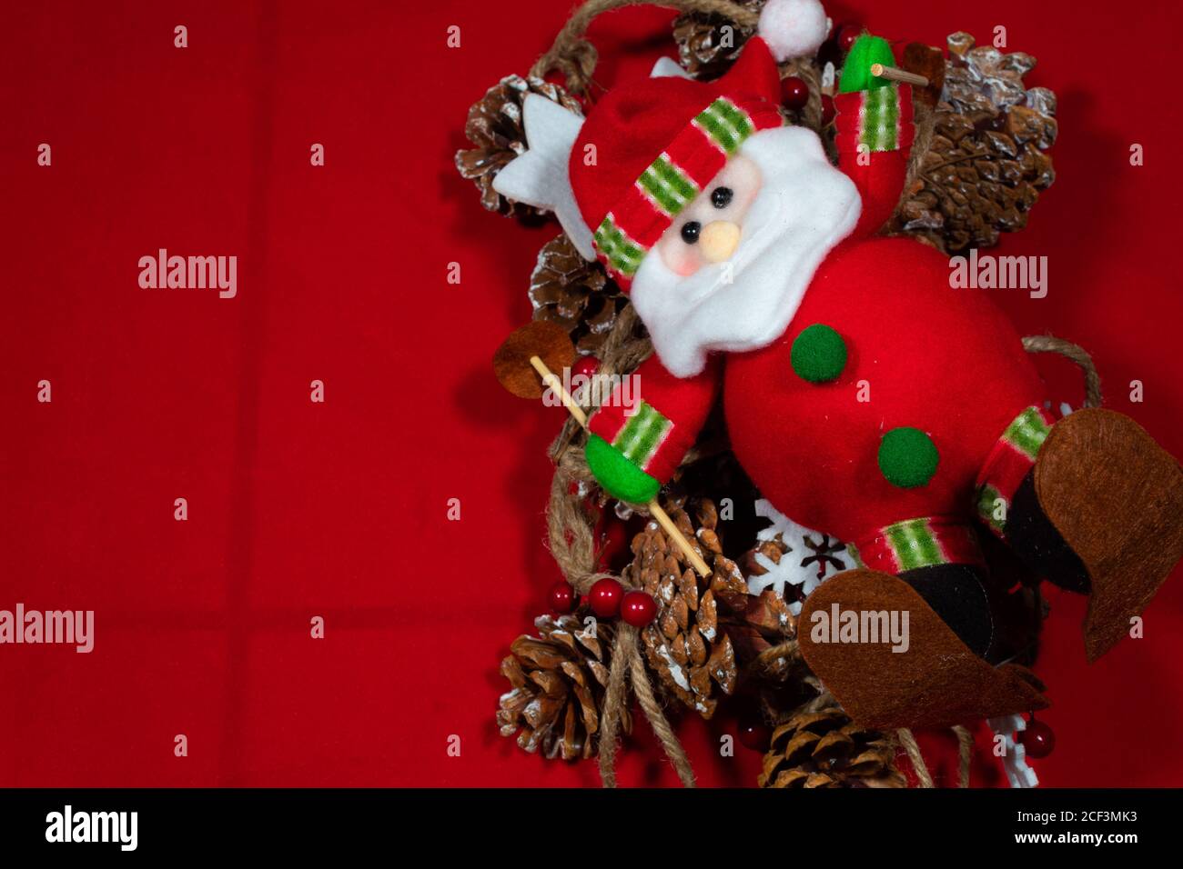 red christmas background with many pine nuts and stars tied to a rope ...