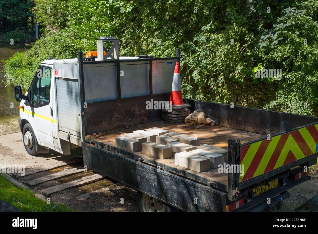 A lorry loaded with stones to repair and ancient bridge Stock Photo - Alamy