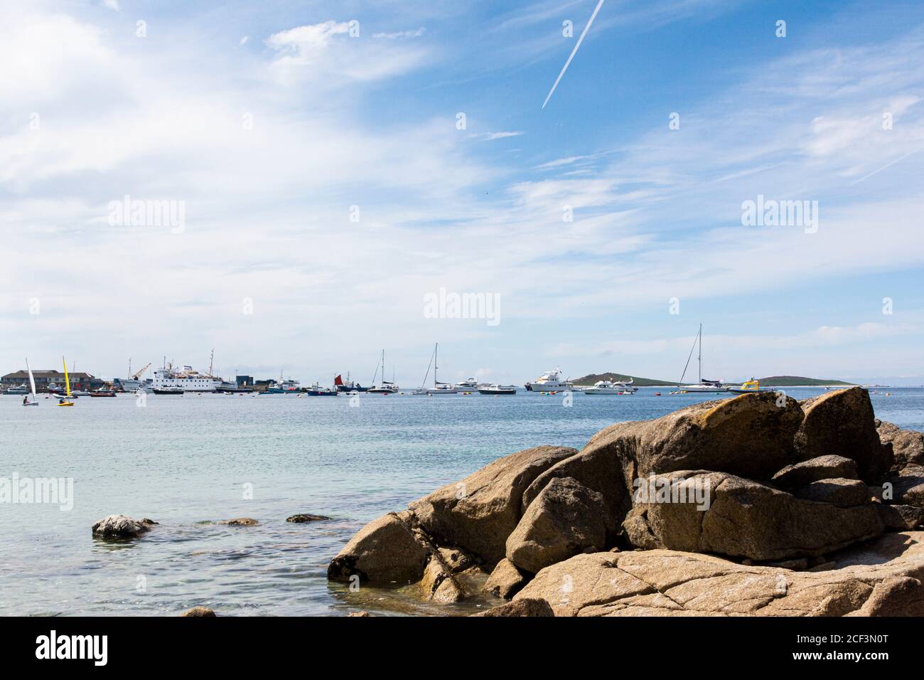 The Scillonian ferry docked on St Mary's Quay with boats at anchor in ...