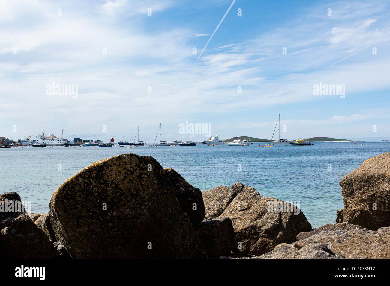 The Scillonian ferry docked on St Mary's Quay with boats at anchor in ...