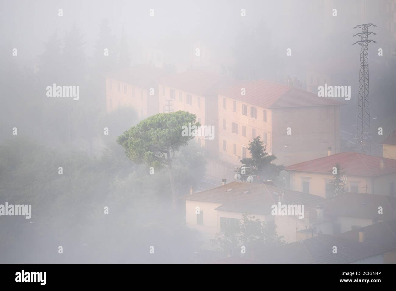 Chiusi Scalo town village houses fog sunrise closeup of rooftop ...