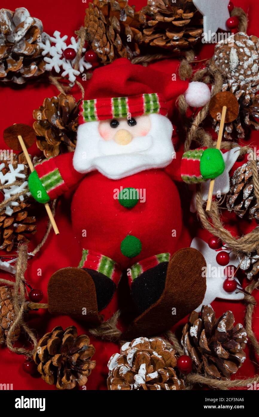 red christmas background with a frame of many pine nuts and stars tied ...