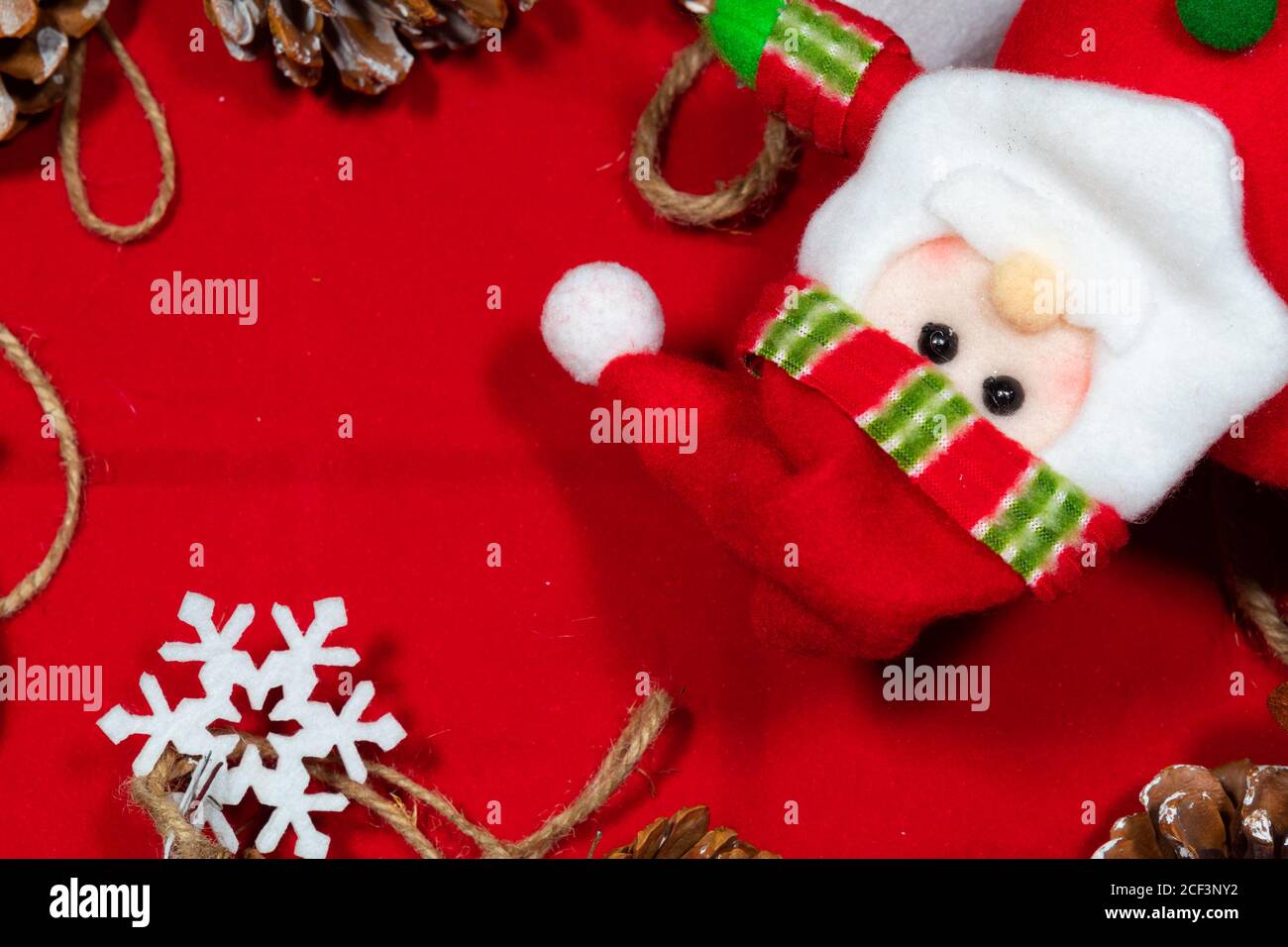 red christmas background with a frame of many pine nuts and stars tied ...