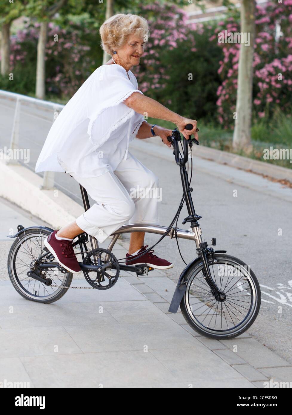 Older lady riding bike hi-res stock photography and images - Alamy