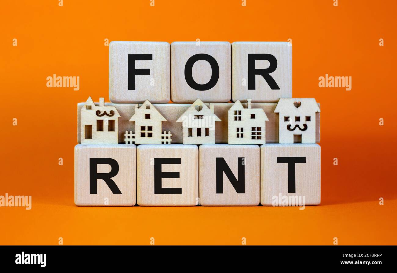 Wooden cubes form the words 'for rent', miniature house. Beautiful ...