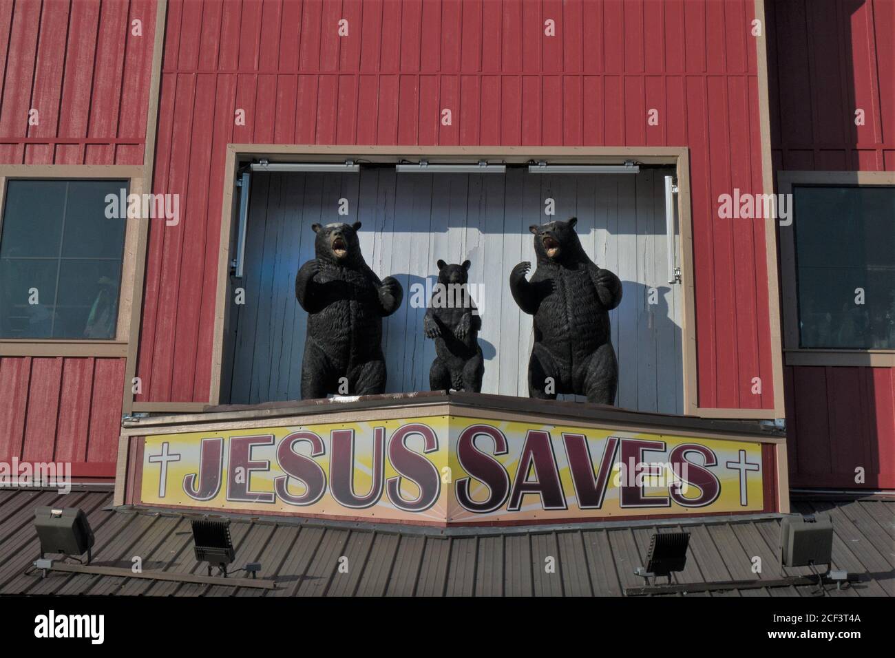 Three bear statues above a sign that reads "Jesus Saves" in Pigeon ...