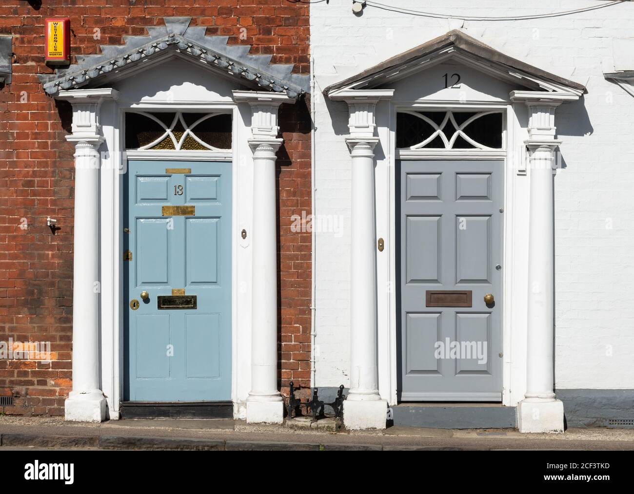 Two adjacent ornate front doors with columns Stock Photo - Alamy