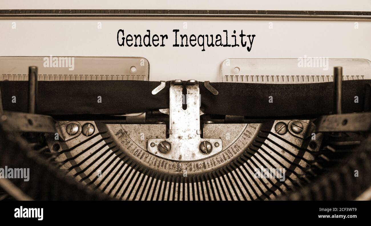 Text 'gender inequality' typed on retro typewriter. Concept. Beautiful ...