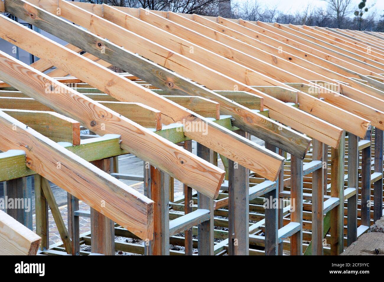 Installation of wooden beams at construction the roof truss system of ...