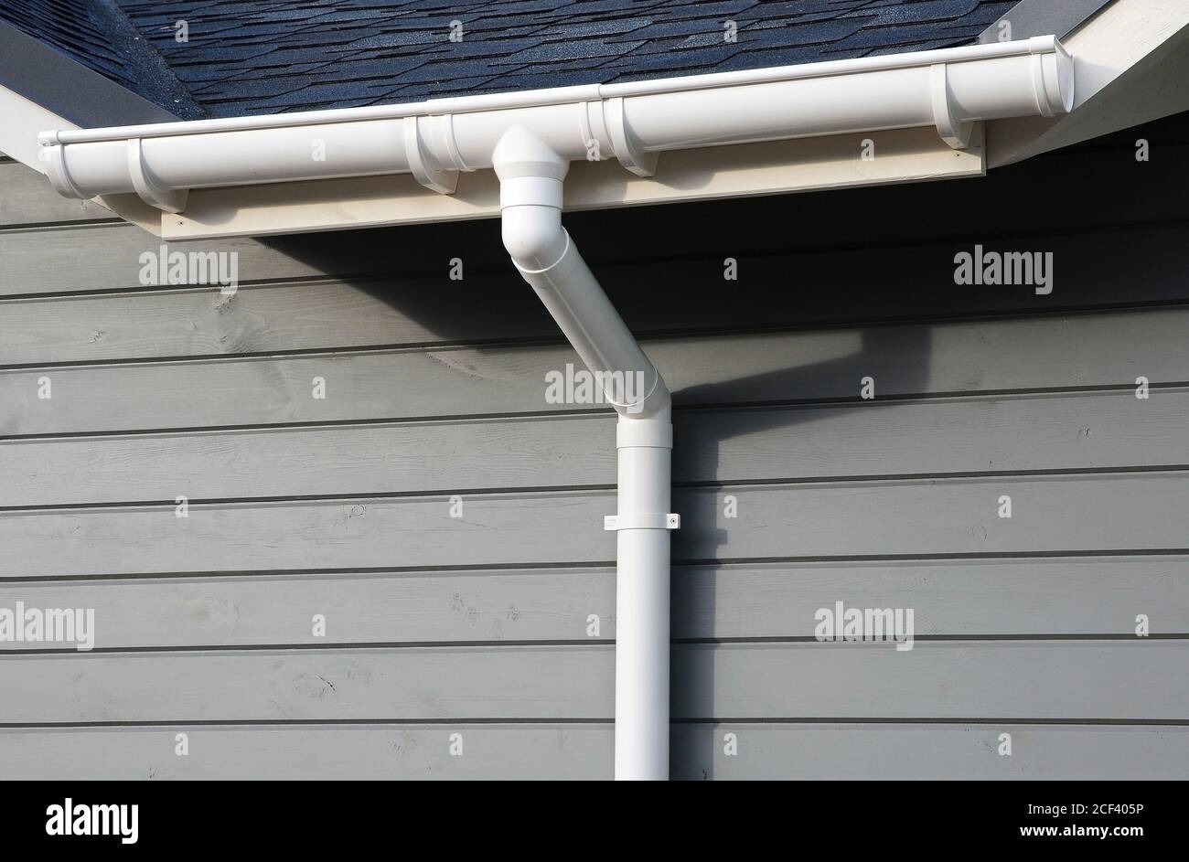 Rain Gutter System and Bitumen Roof Shingles Stock Photo - Alamy