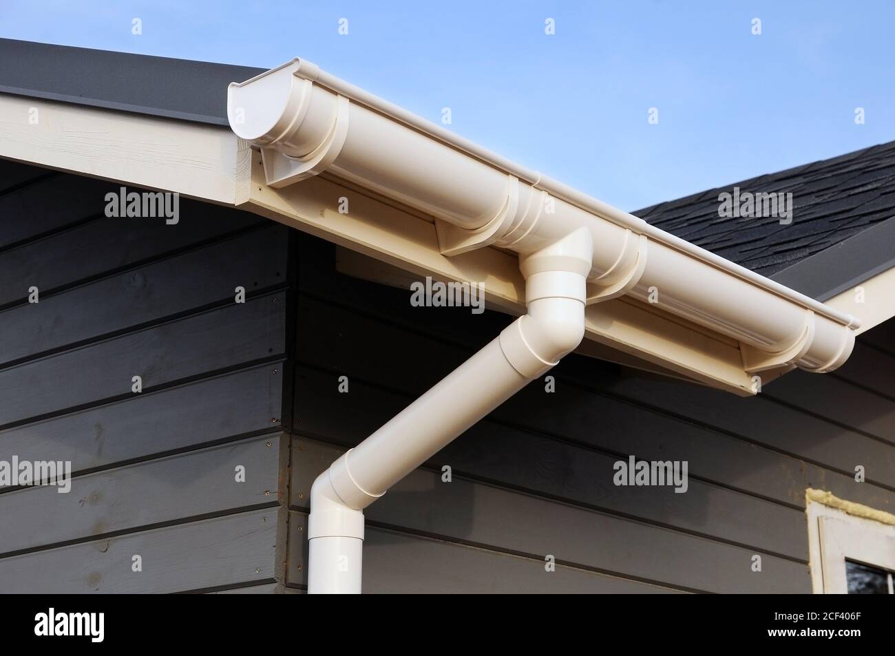 Rain Gutter System and Bitumen Roof Shingles Stock Photo - Alamy
