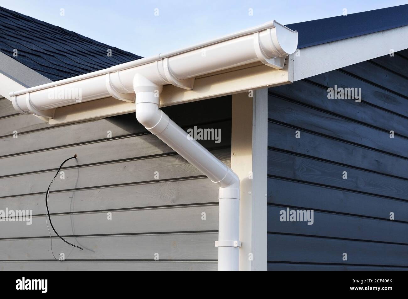 Rain Gutter System and Bitumen Roof Shingles Stock Photo - Alamy