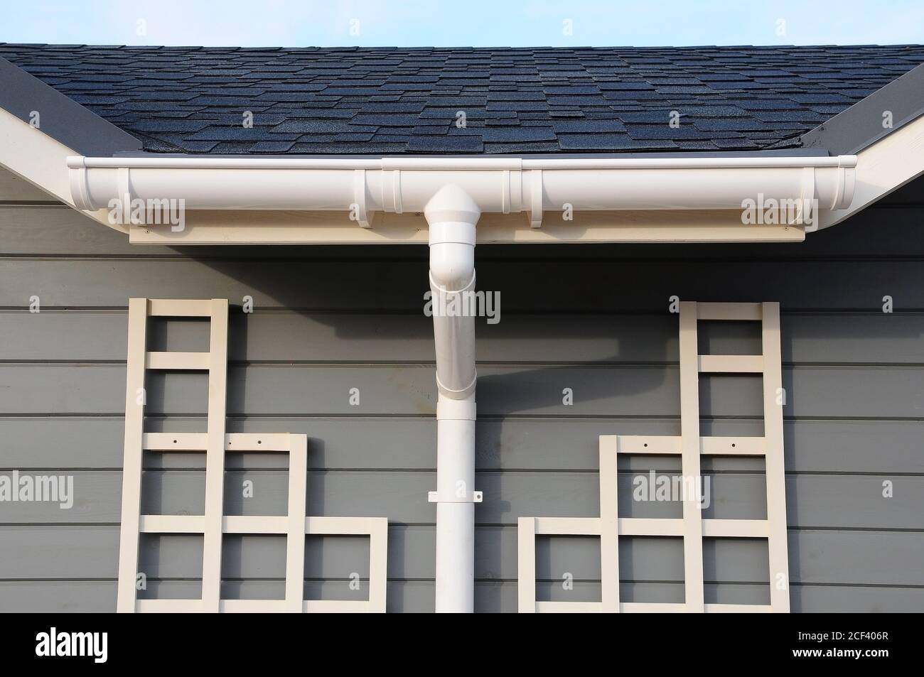 Rain Gutter System and Bitumen Roof Shingles Stock Photo - Alamy