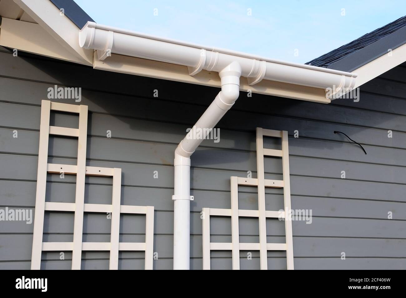 Rain Gutter System and Bitumen Roof Shingles Stock Photo - Alamy