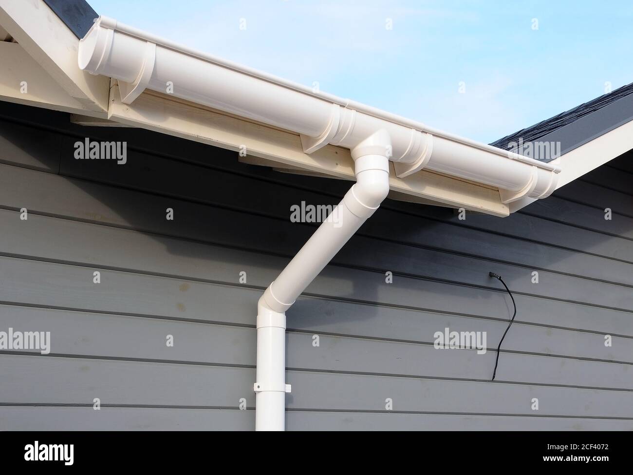 Rain Gutter System and Bitumen Roof Shingles Stock Photo - Alamy