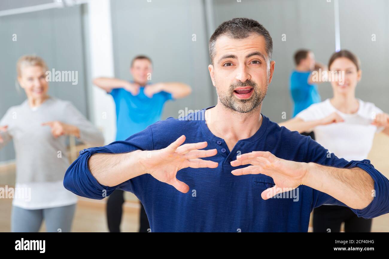 Portrait of cheerful adult man enjoying vigorous dances in modern dance ...