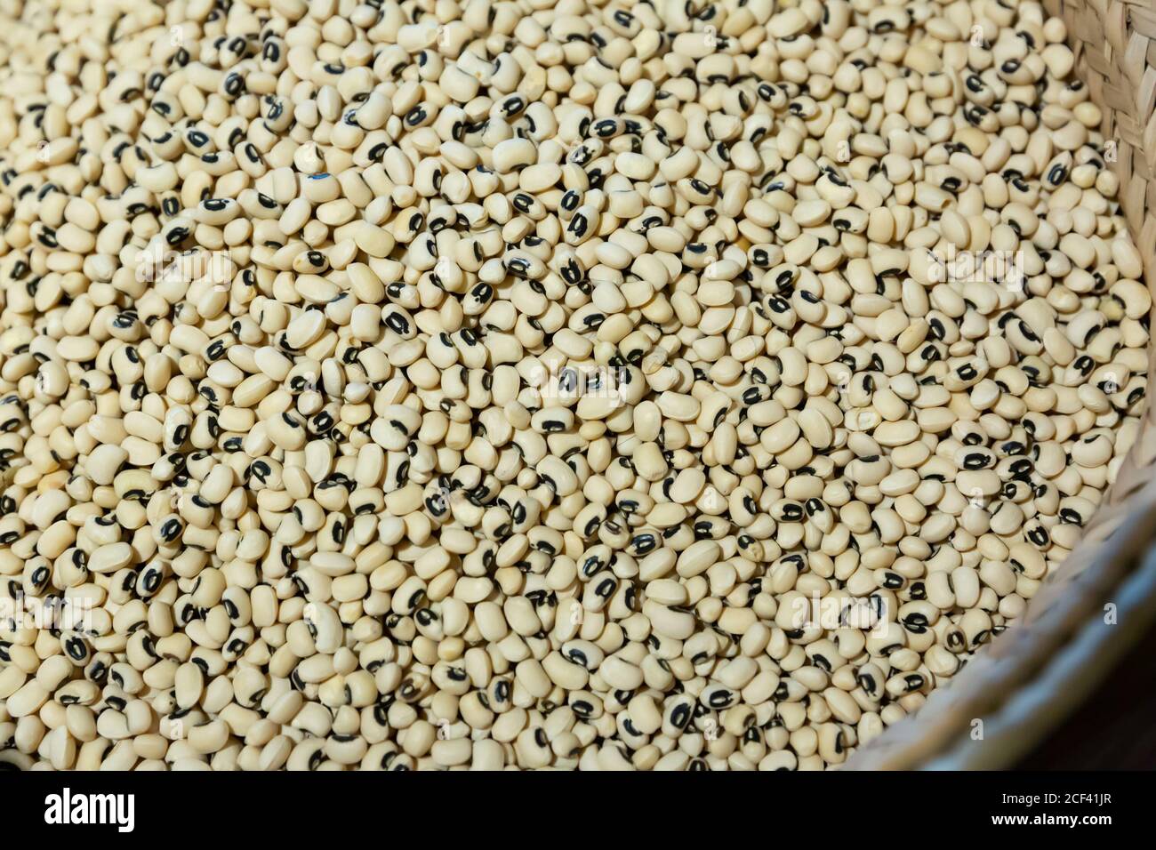 Dried white bean in wicker basket on grocery shop display. Organic bulk ...