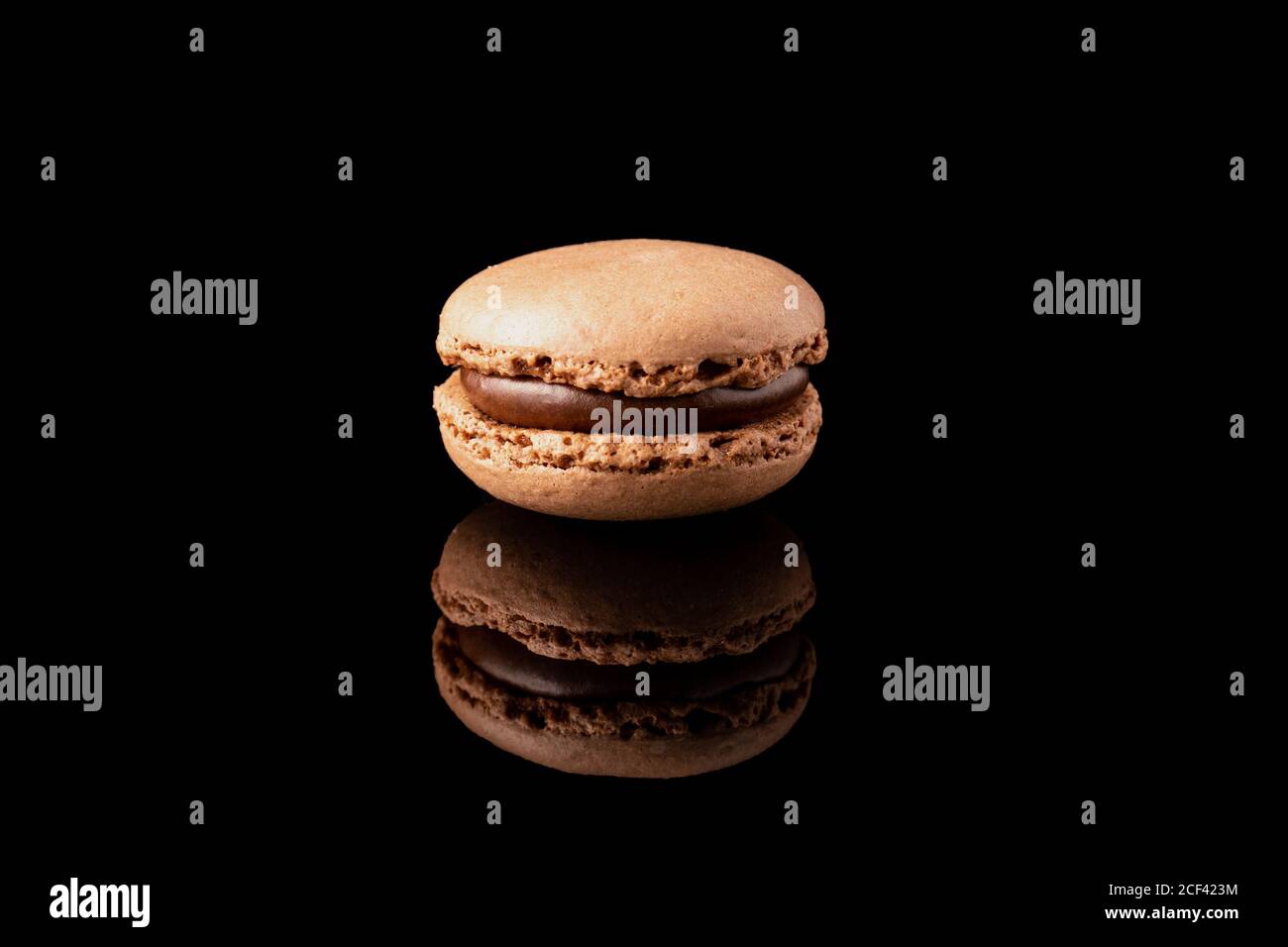 Pink tasty macaroon displayed on black background Stock Photo - Alamy