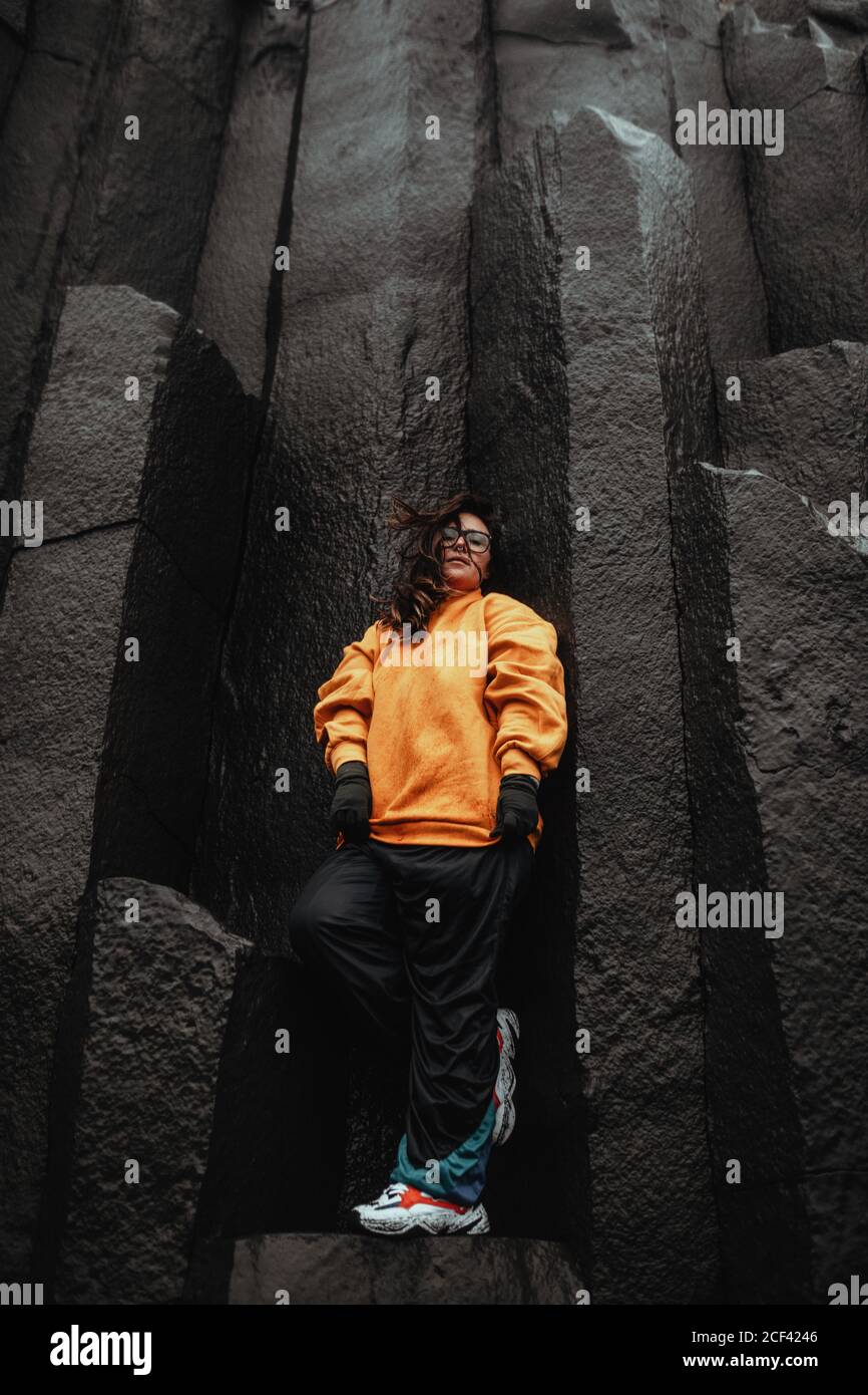 From below of young attractive female in trendy sportive clothes ...