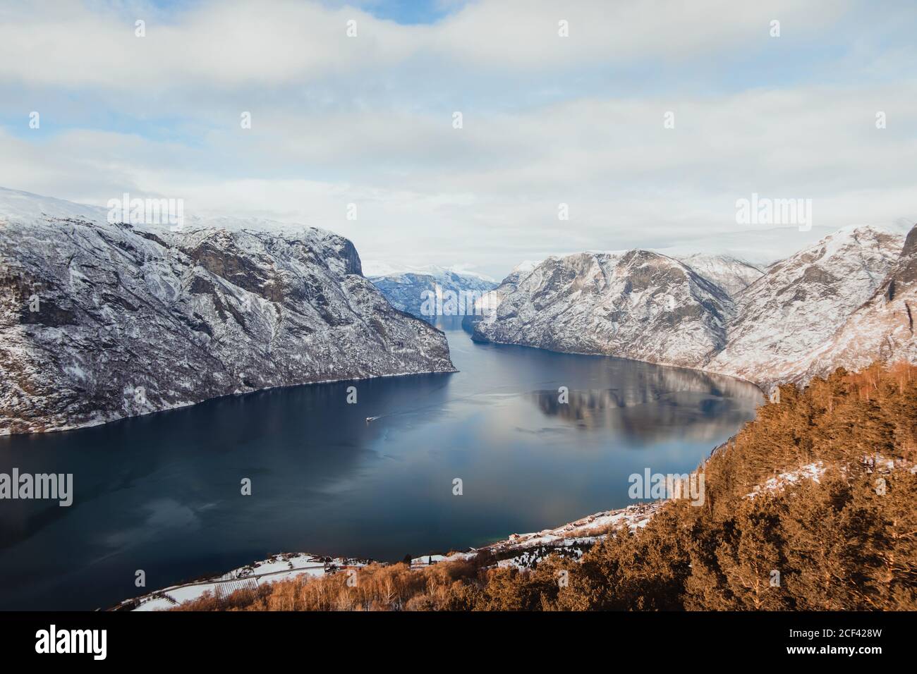 Lake between hills in snow Stock Photo - Alamy