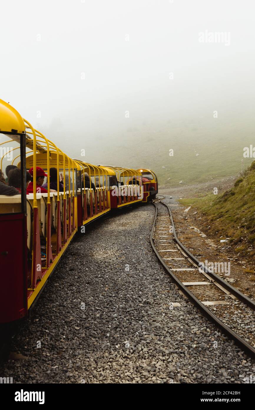 Small train riding on tourist railroad on misty day in amazing ...