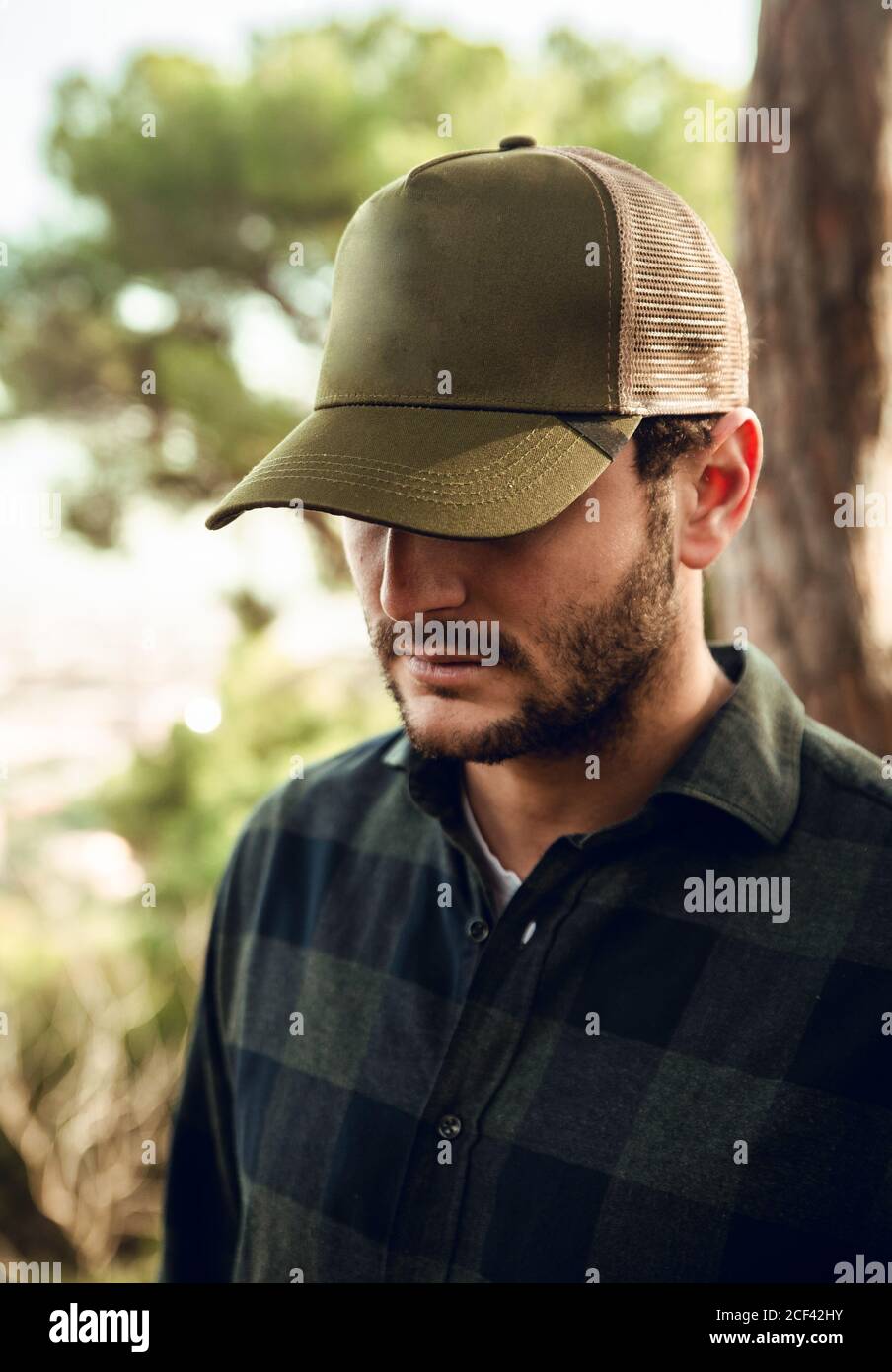 unrecognizable portrait of brunet man in checkered shirt and baseball ...