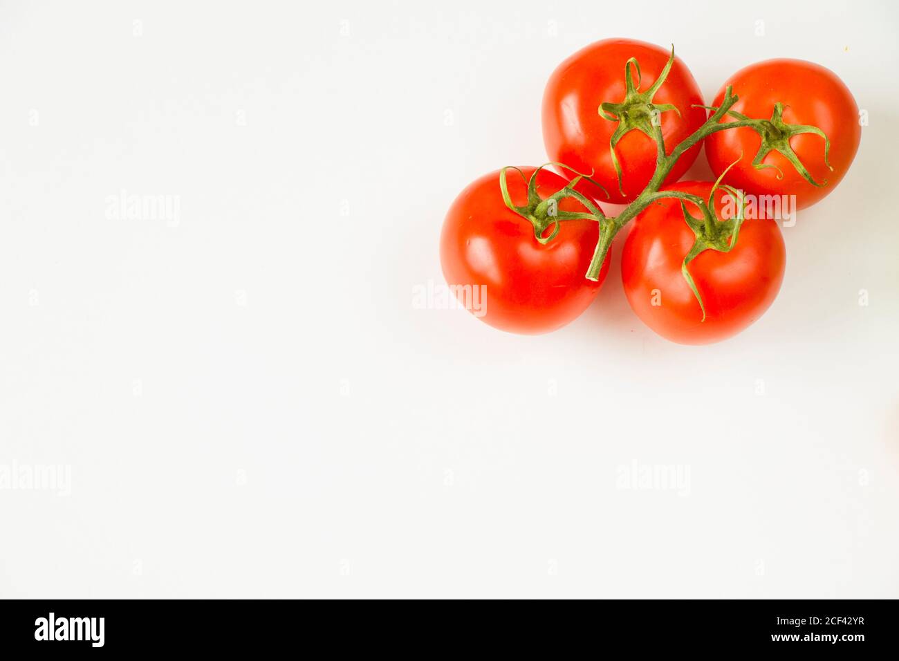Four colorful red tomatoes hi-res stock photography and images - Alamy