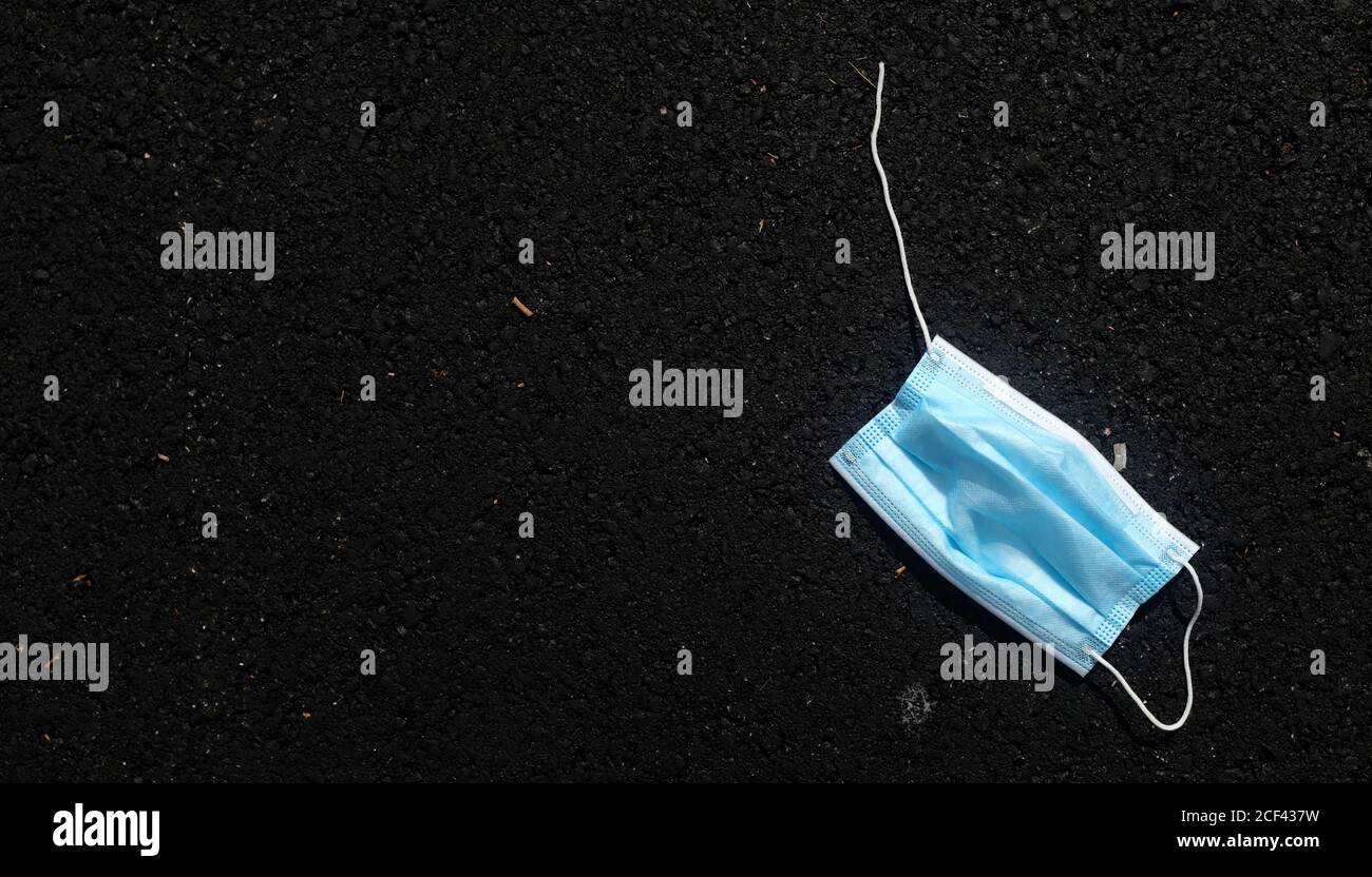 Blue Disposable Fask Mask On Black Asphalt Stock Photo - Alamy
