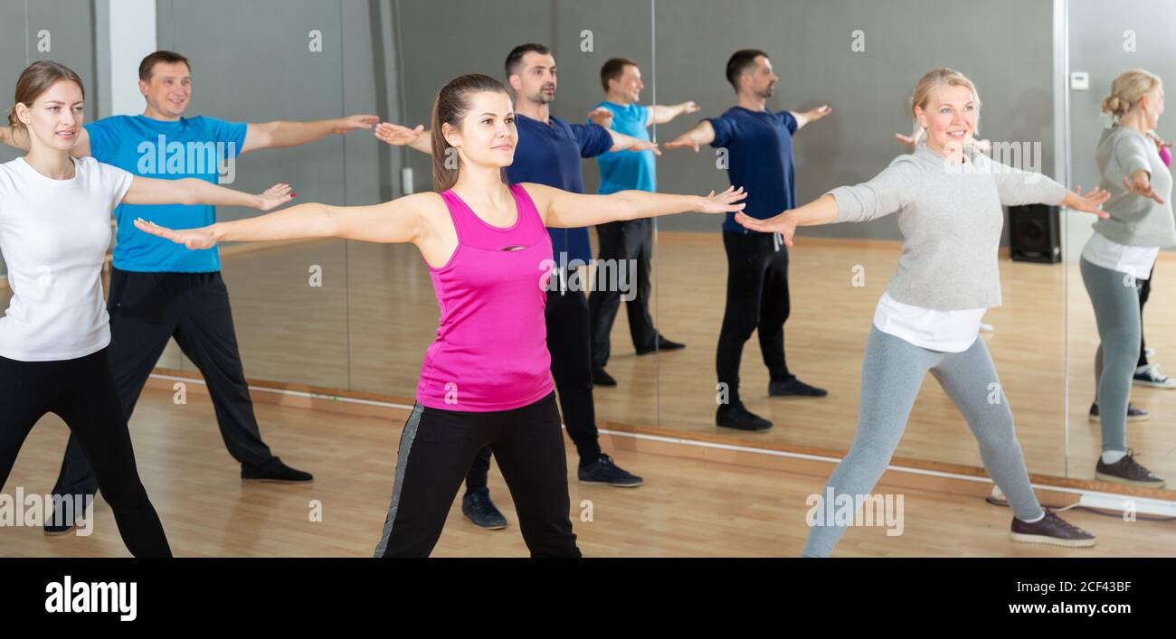 Group Of Different Ages Women And Men Doing Stretching Exercises