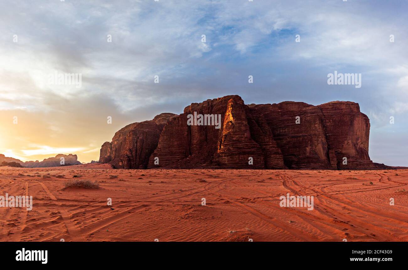 Amazing view of red sand desert landscape with rocky mountain during ...