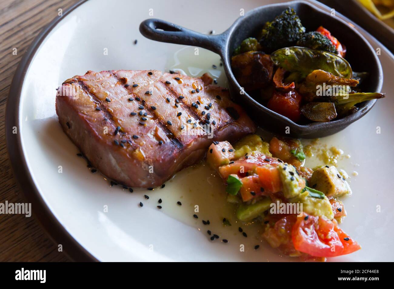 Healthy dinner, braised tuna fillet with grilled vegetables and salad ...