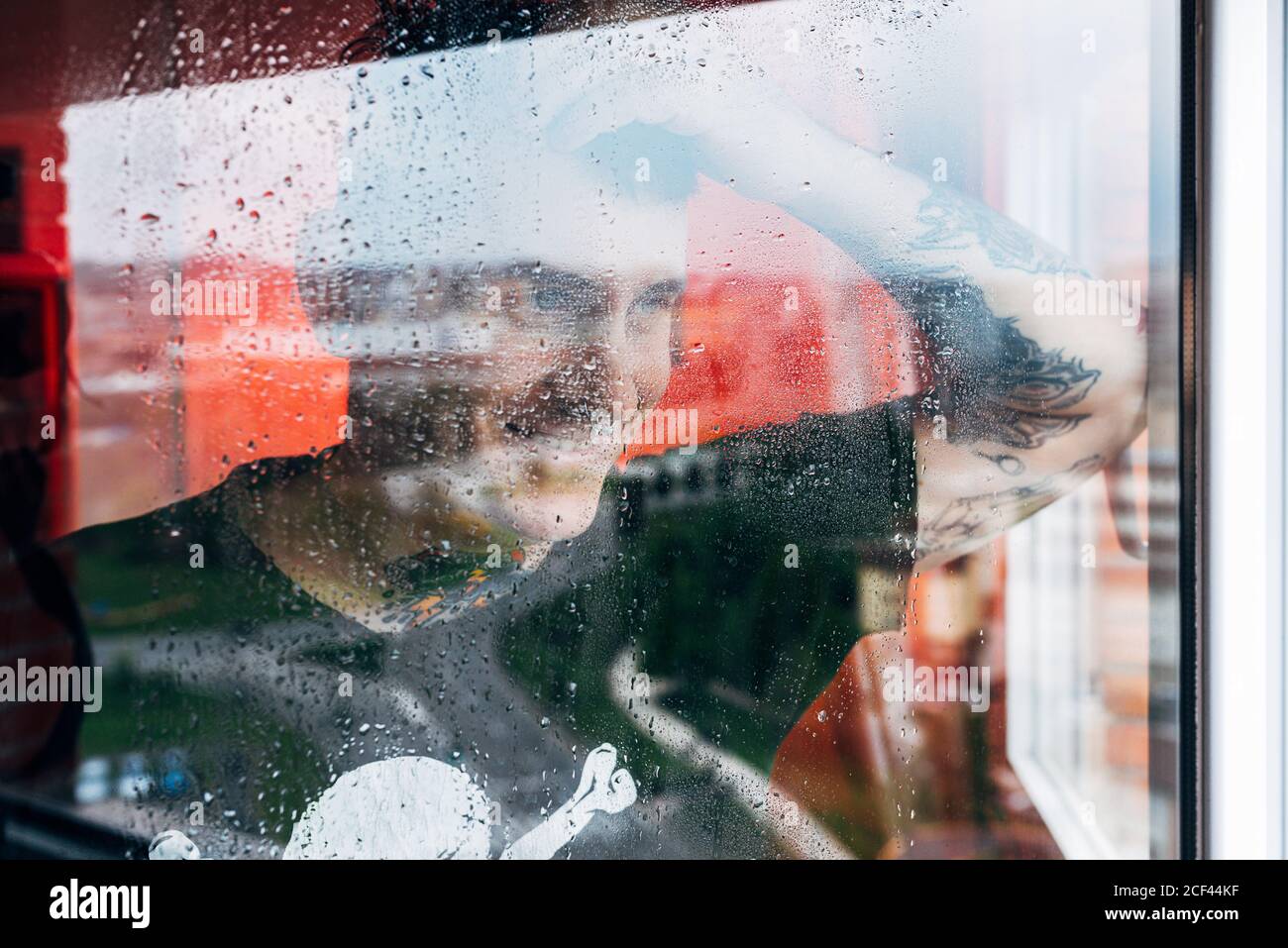 man looking through window Stock Photo - Alamy