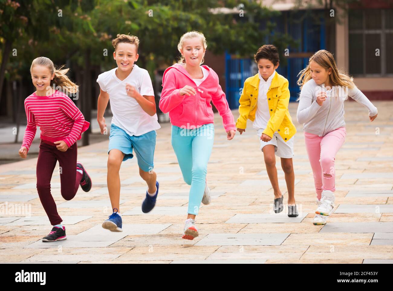 Glad children are jogging together in the park and having fun Stock ...