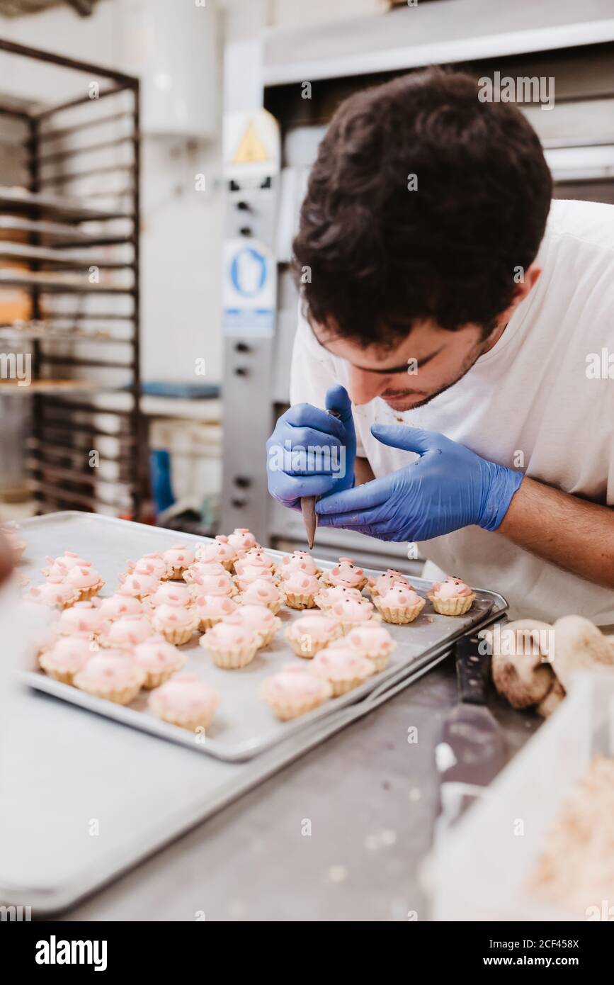cook squeezing fresh pastry dough on tray with paper Stock Photo - Alamy