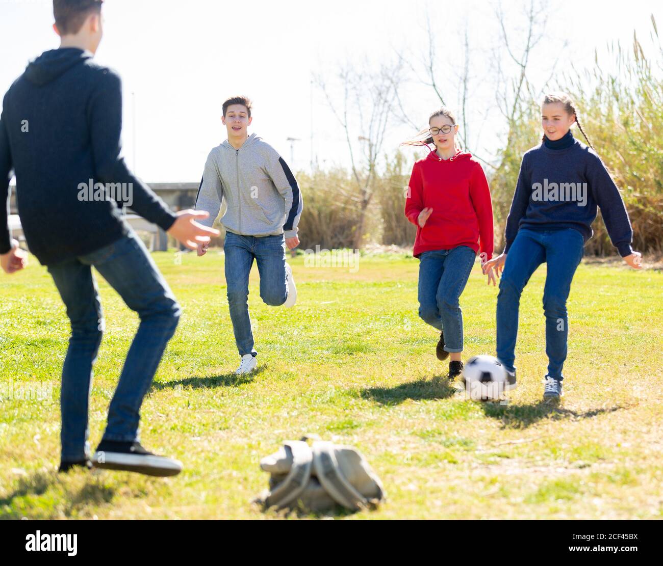 Group of sports teenagers having fun together outdoors, playing ...