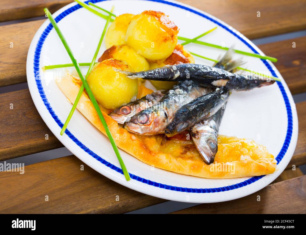 Portion of fried anchovies served with potato croquettes, tortillas and ...