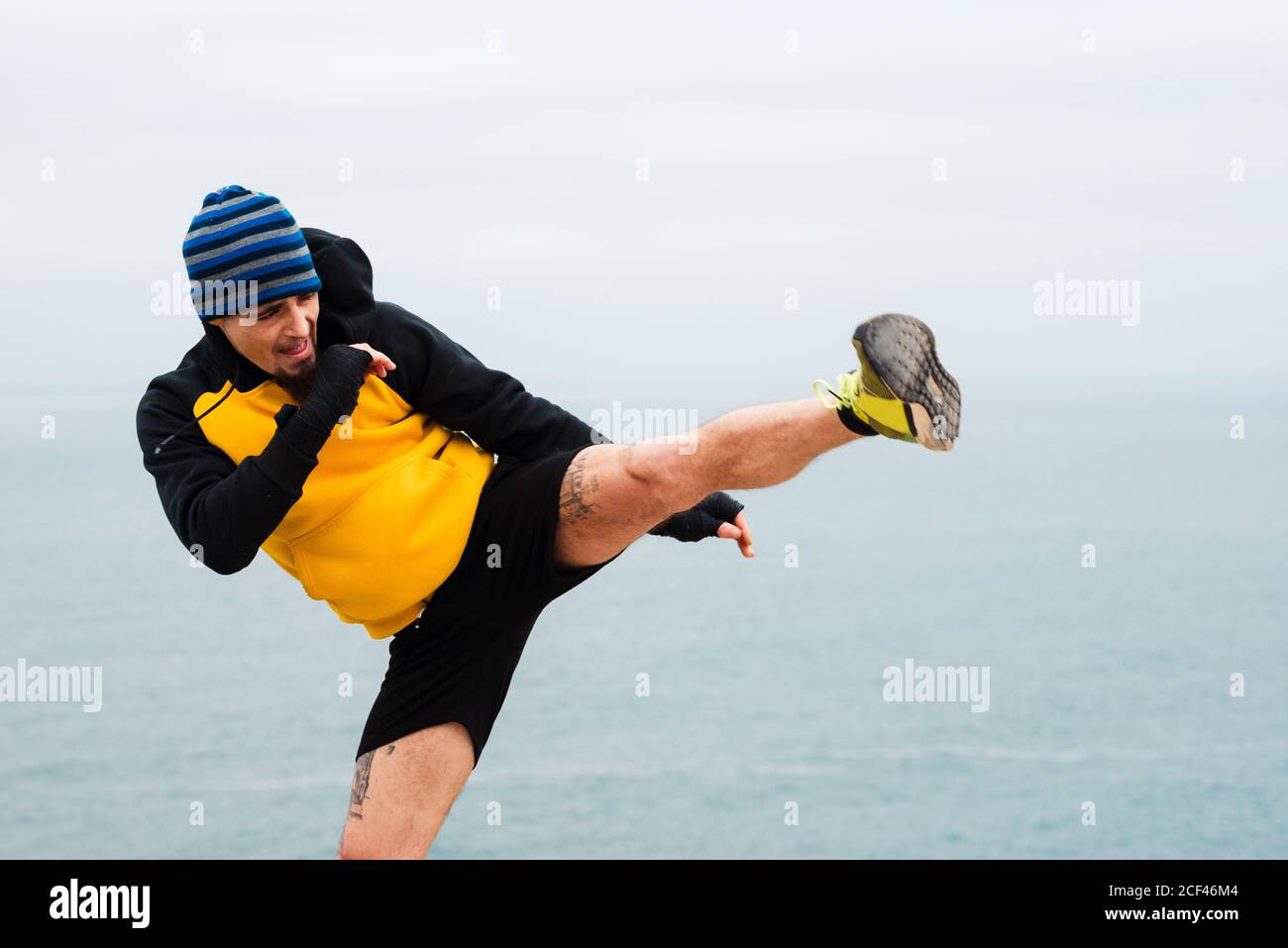 Strong fighter practicing kicks in hi-res stock photography and images ...