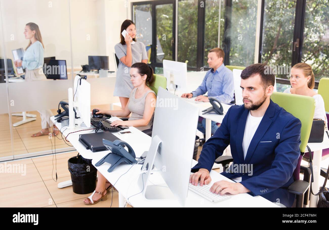 Group of successful diligent positive business people during daily work ...