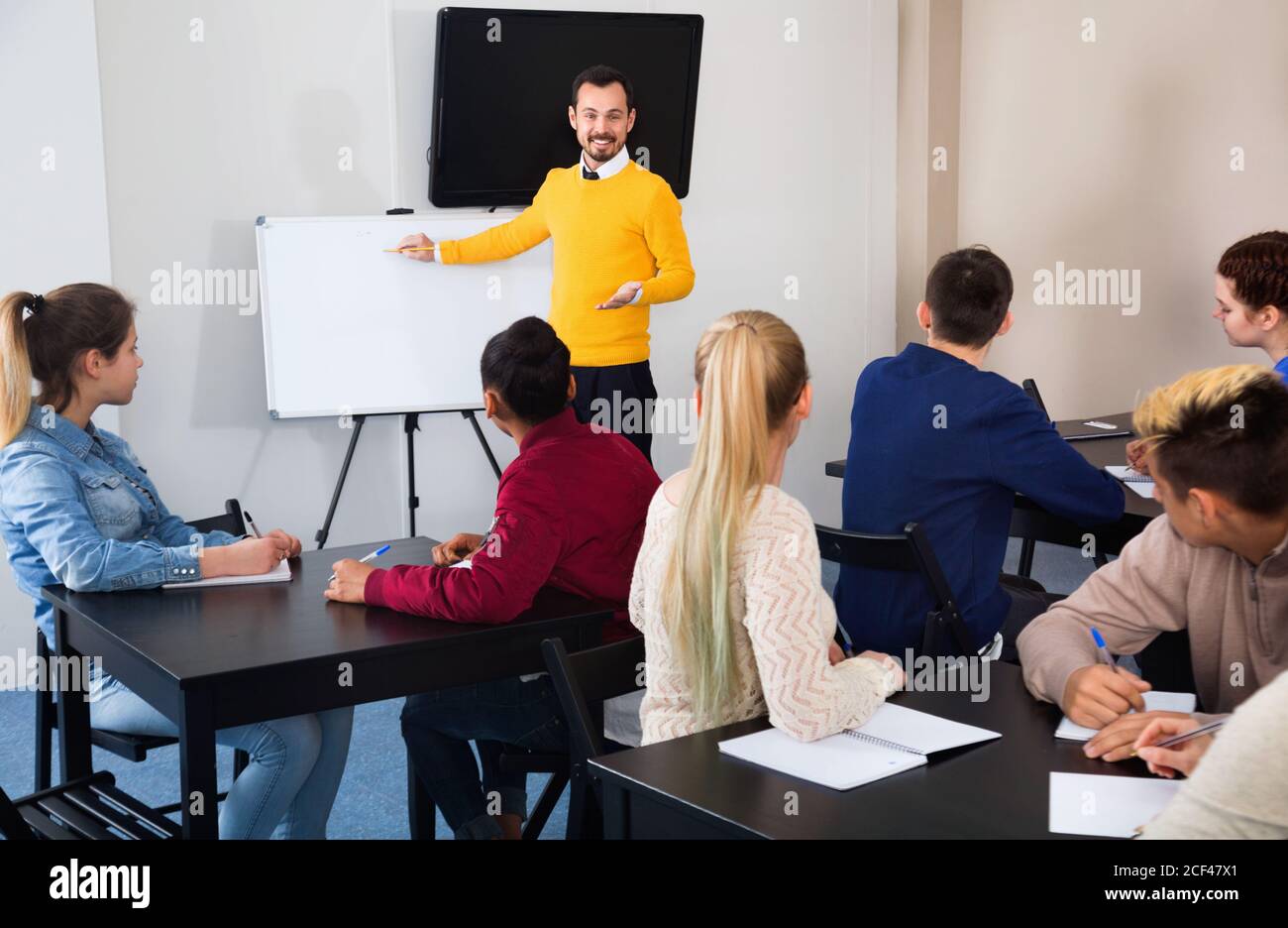 Diligent positive fellow students having group work tasks during school ...