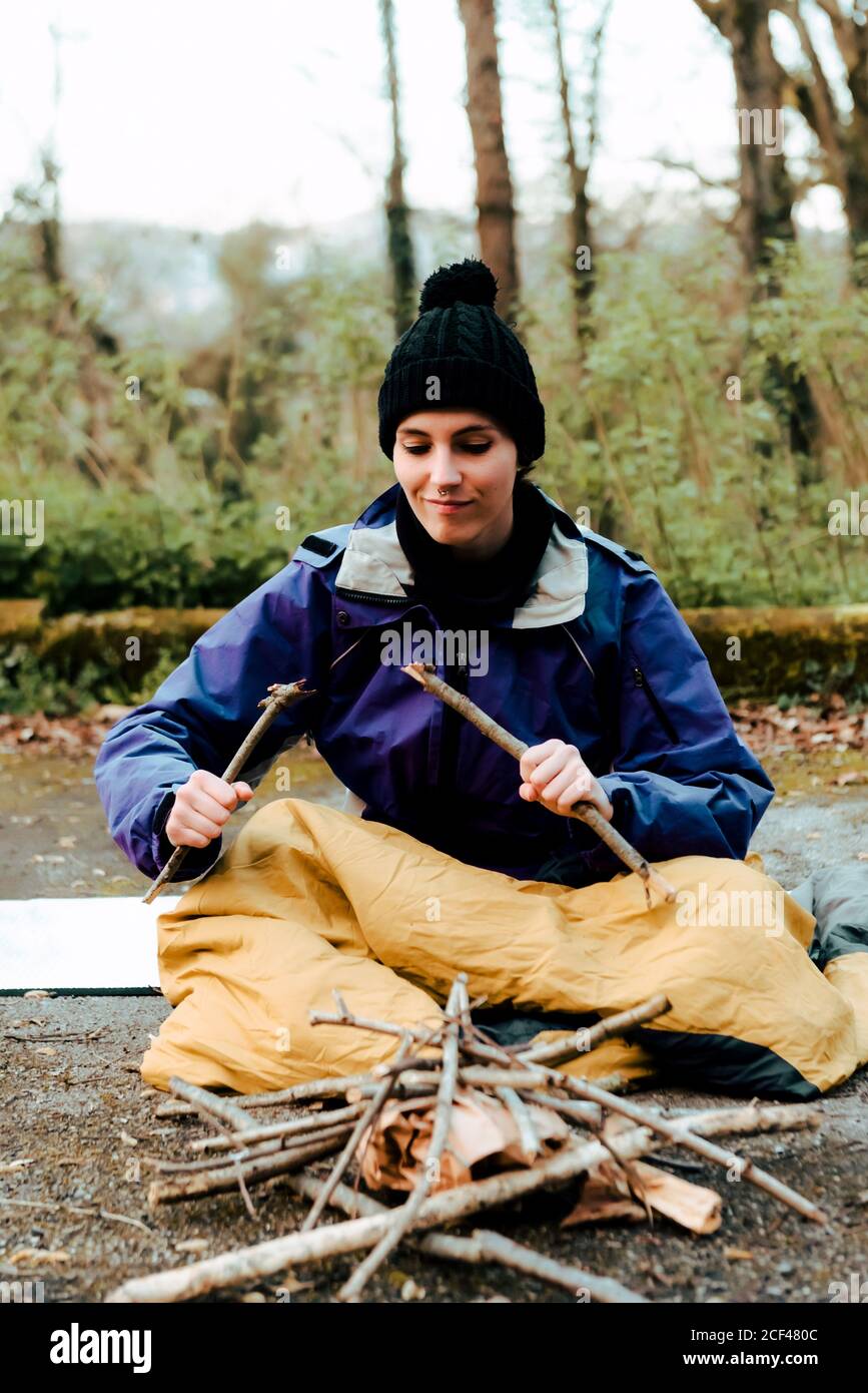 Woman starting campfire hi-res stock photography and images - Alamy