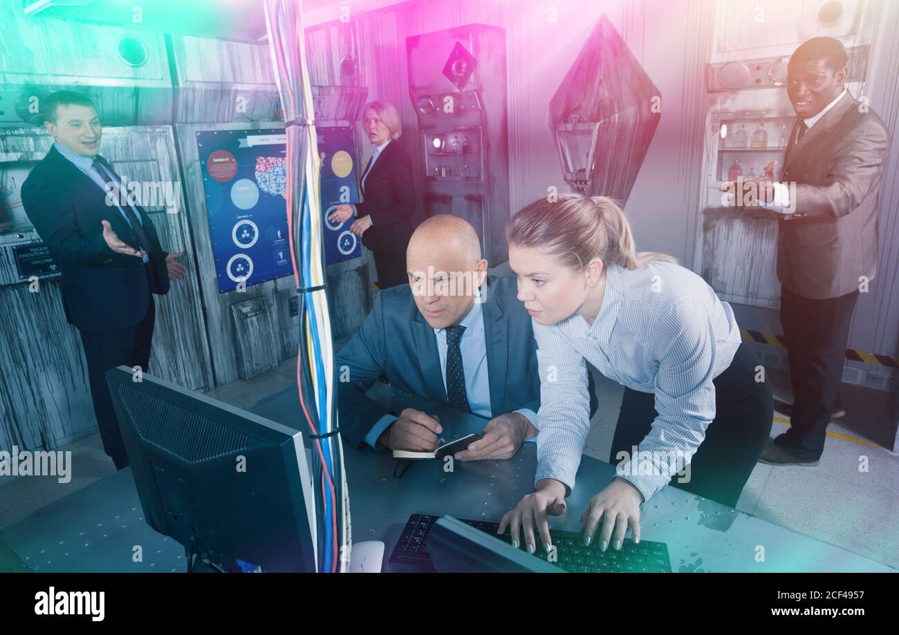 Toned image of businesspeople solving different conundrums in quest ...