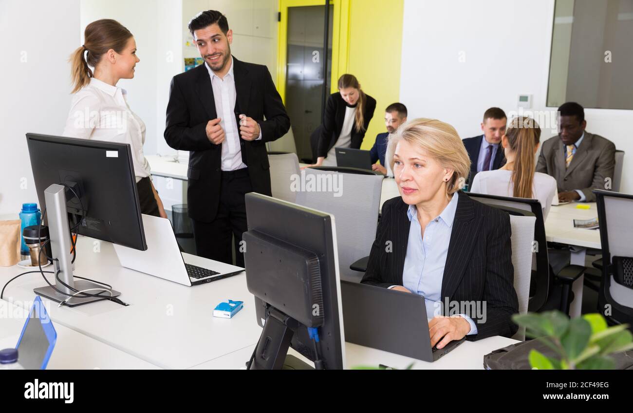 Successful coworkers engaged in business activities in busy open plan office Stock Photo - Alamy