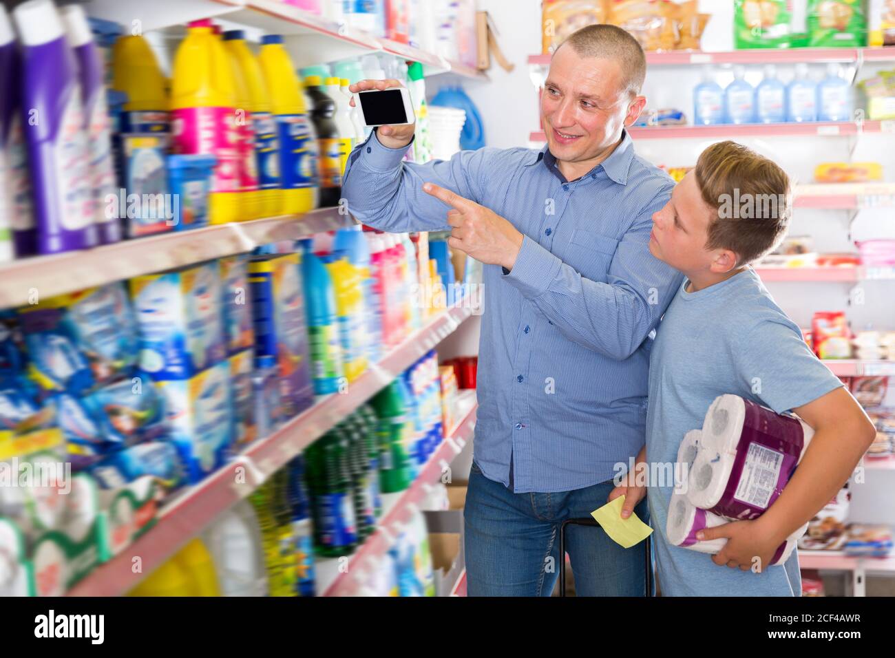 Man with boy consulted about purchasing in store Stock Photo - Alamy