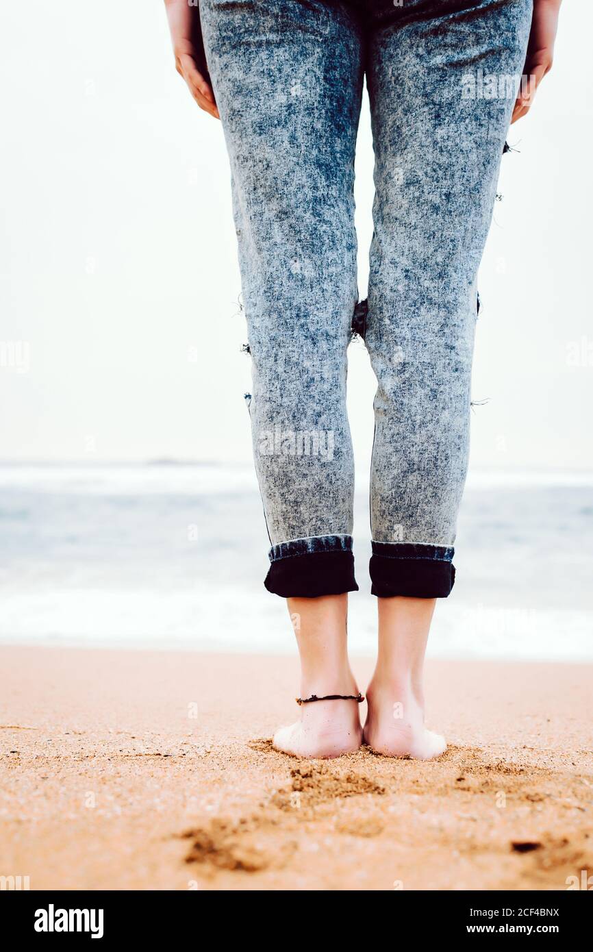 Woman in jeans on the beach hi-res stock photography and images - Alamy