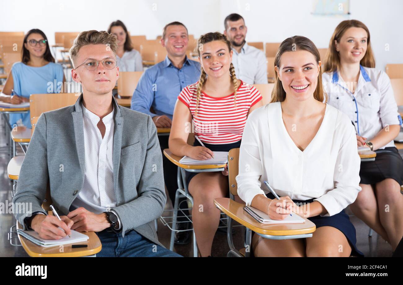Portrait of group of different age people in lecture hall at extension ...