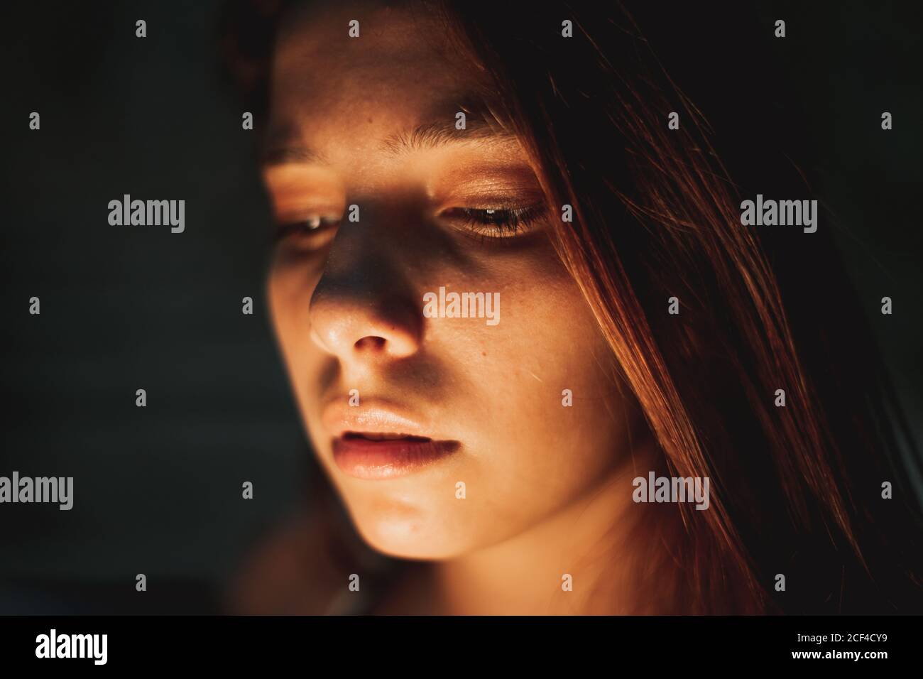 Closeup of thinking sensual young Woman looking at flame thoughtful ...