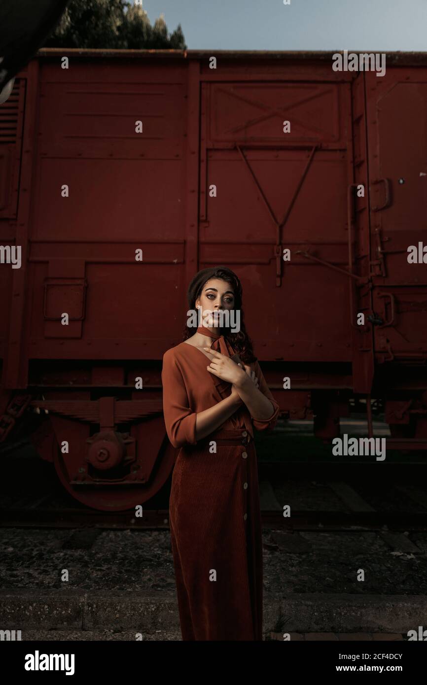 Dark haired female totally wearing terracotta clothes in vintage style ...